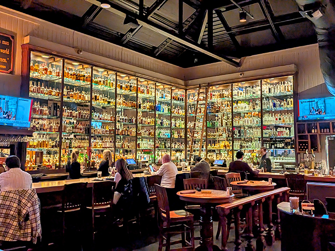 A bar backed with bottles that sparkle like an adult candy store, where each shelf tells a different story of distillation and delight.