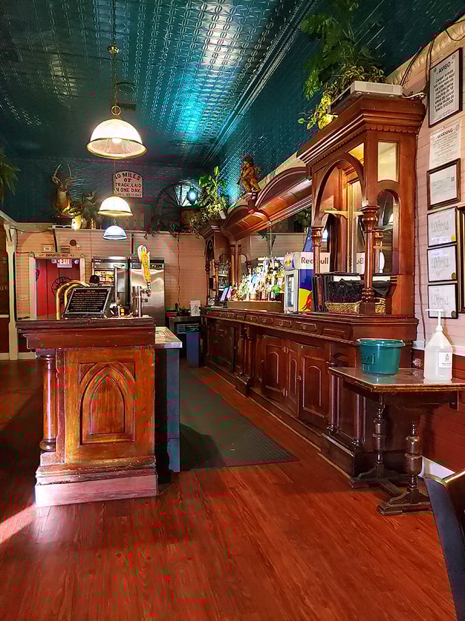 The bar isn't just serving drinks; it's preserving history with every pour beneath that striking teal ceiling.