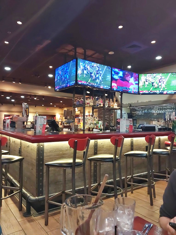 The bar area serves as command central—where sports fans gather to debate games while unanimously agreeing on the quality of the barbecue.
