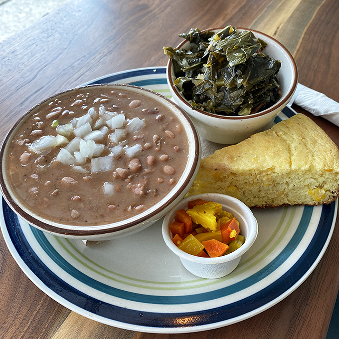 This isn't just lunch&mdash;it's a Southern trinity: pinto beans swimming with ham, collard greens cooked to silky perfection, and cornbread that could make a grown man weep.