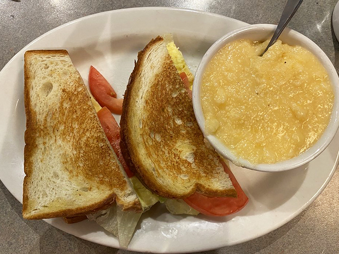 A breakfast sandwich that understands you, paired with cheese grits that could convert even the most dedicated Northerner to Southern ways.