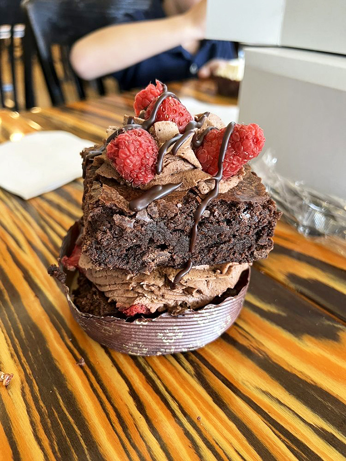 The brownie tower isn't just dessert &ndash; it's architecture. Layers of chocolate and raspberry create a skyscraper of flavor that defies gravity and willpower.