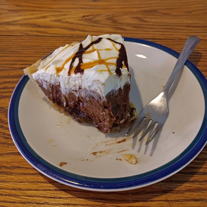 Chocolate pie drizzled with caramel&mdash;proof that sometimes more is more. The fork stands ready for action.