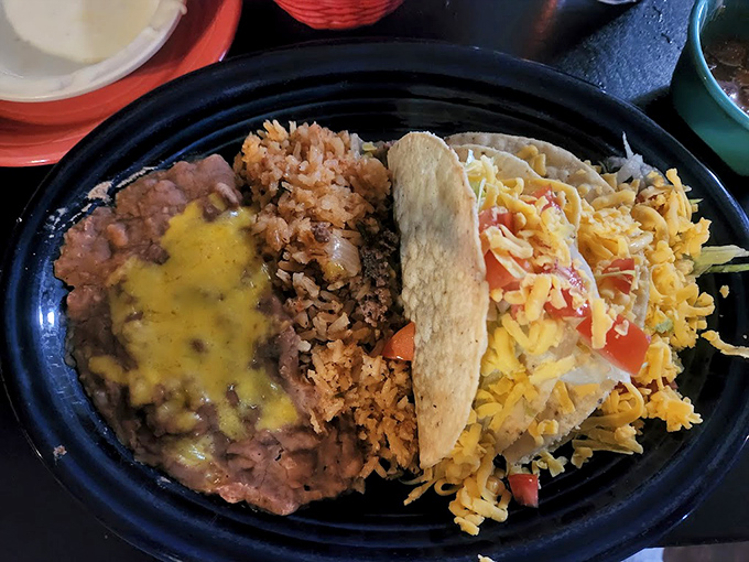 Carne asada tacos with a generous sprinkle of cheese—simple street food elevated to an art form.