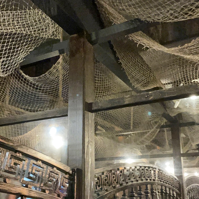 Fishing nets draped across the ceiling complete the underwater fantasy, as if you're dining beneath the waves instead of just enjoying their bounty.