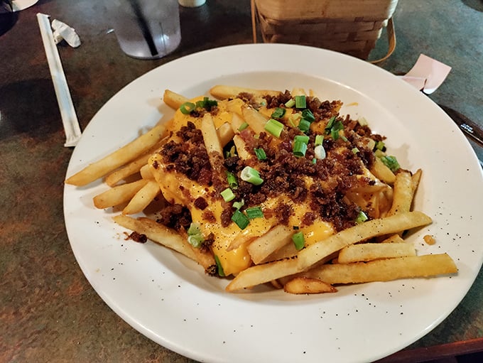 Loaded fries that laugh in the face of restraint&mdash;golden potatoes baptized in melted cheese and crowned with bacon bits and green onions.