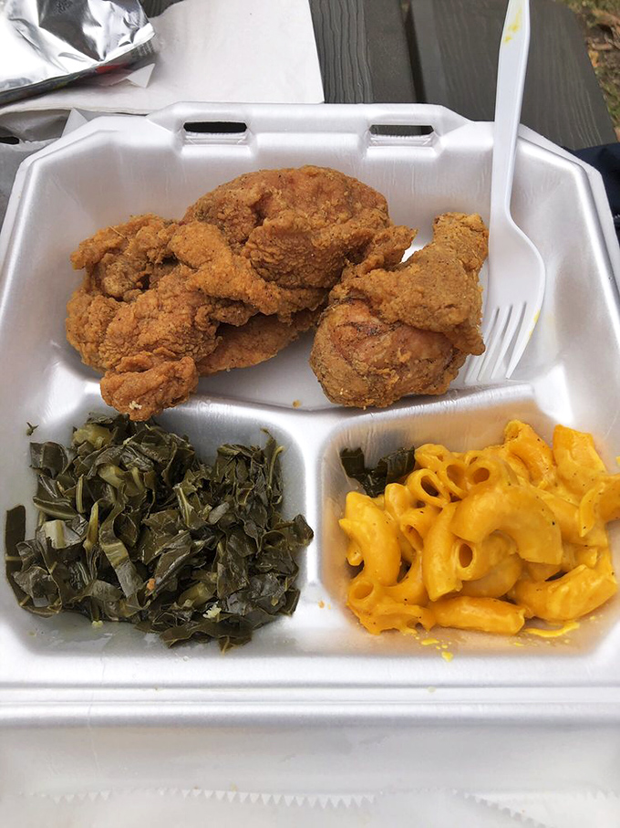 Fried chicken so perfectly golden it belongs in Fort Knox, with collard greens and mac and cheese providing the perfect supporting cast.