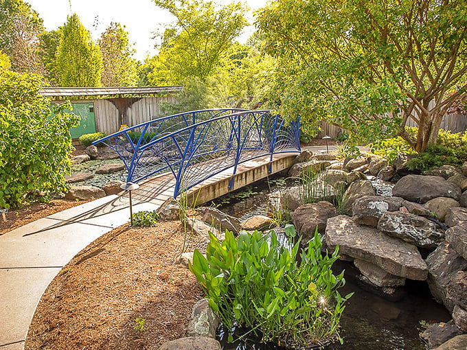 A blue bridge arches gracefully over tranquil waters, proving that engineering and poetry aren't mutually exclusive after all.