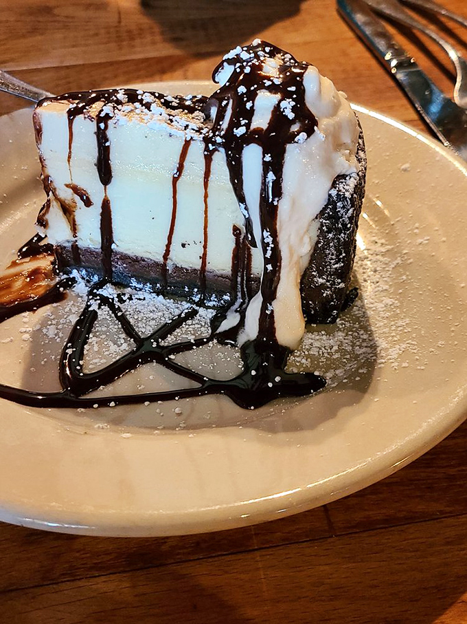 Chocolate cheesecake draped in sauce and whipped cream &ndash; dessert or art installation? The debate continues until the last bite disappears.