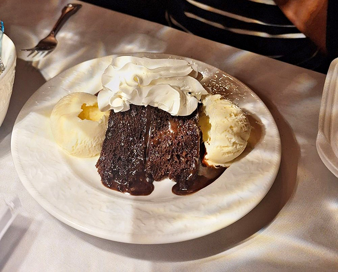 Chocolate cake surrounded by ice cream islands in a sea of whipped cream. Dessert that makes you glad you saved room &ndash; or wish you had.