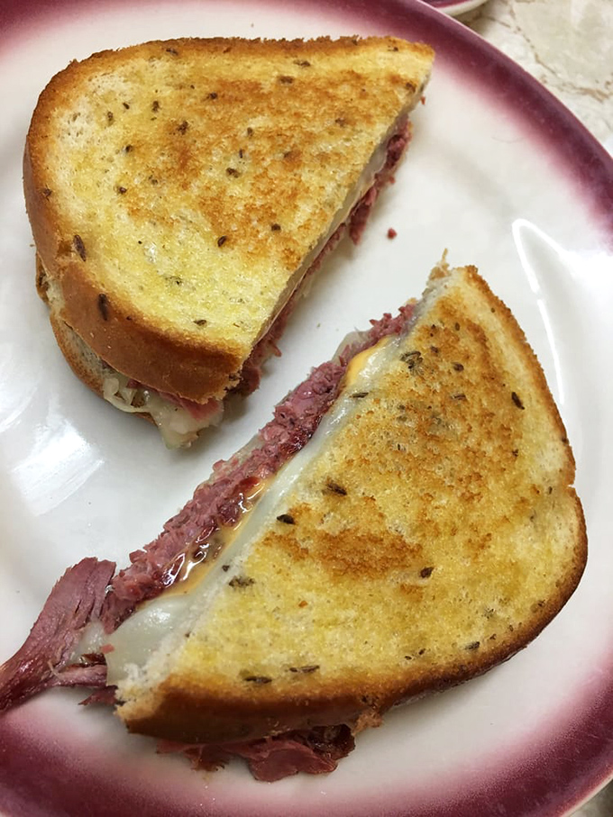 The Reuben: where corned beef, sauerkraut, Swiss, and Russian dressing perform a sandwich symphony that puts modern "food hall" creations to shame.