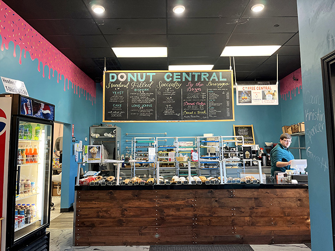 Behind the rustic wooden counter, donut magic happens daily. The display cases showcase edible treasures like a museum of morning delights.