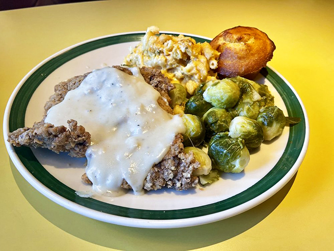 Country fried steak swimming in pepper gravy with a supporting cast of Brussels sprouts and mac & cheese&mdash;Southern comfort on a plate.