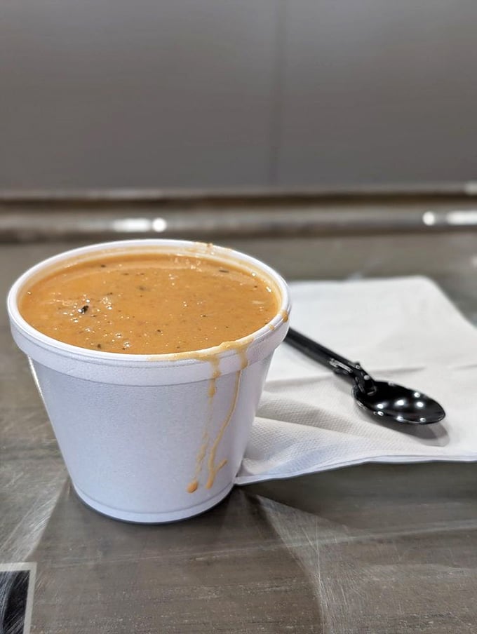 A cup of what appears to be seafood bisque or chowder&mdash;proof that sometimes the most humble containers hold the greatest treasures.