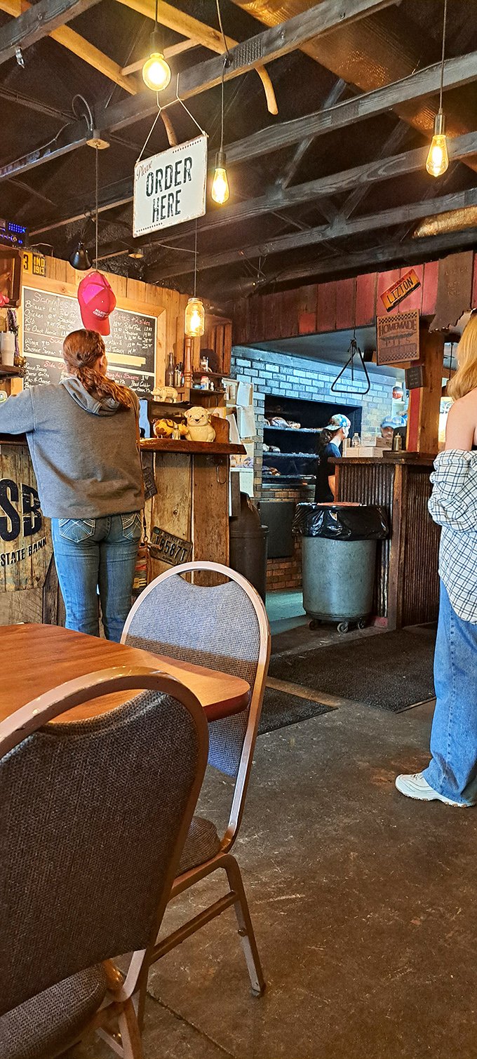 The "ORDER HERE" sign might as well say "HAPPINESS THIS WAY." Edison bulbs guide you like runway lights to barbecue nirvana.