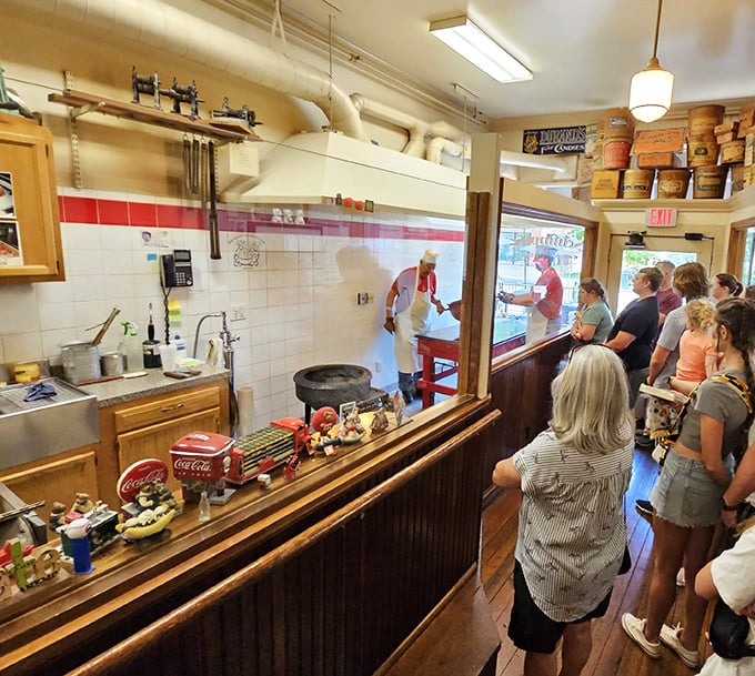 The demonstration area—where sugar transforms from ordinary to extraordinary while onlookers witness alchemy that predates electricity.