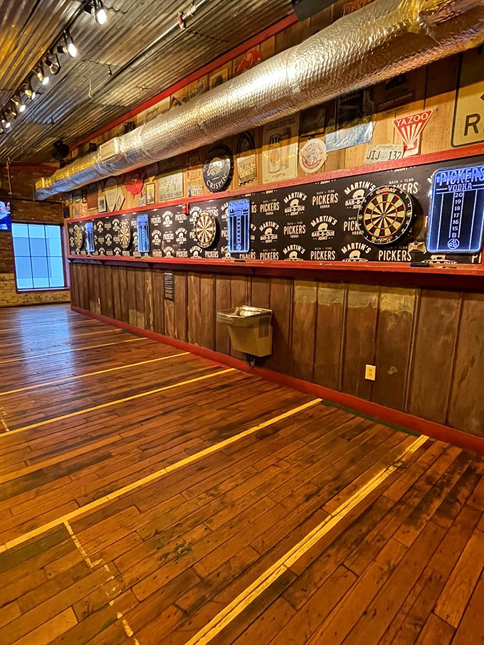 A wall of darts and memorabilia that tells you this place values tradition, community, and friendly competition fueled by barbecue.