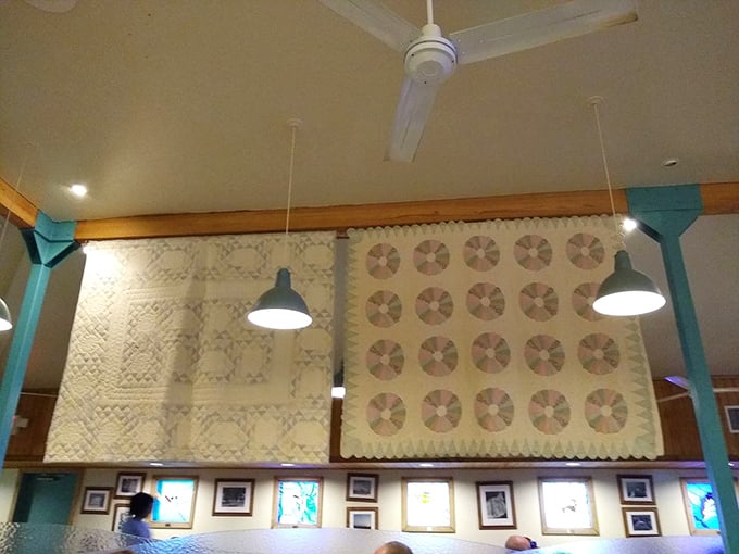 Handmade quilts hanging from the ceiling tell stories of Arkansas tradition, adding warmth that goes beyond the food.