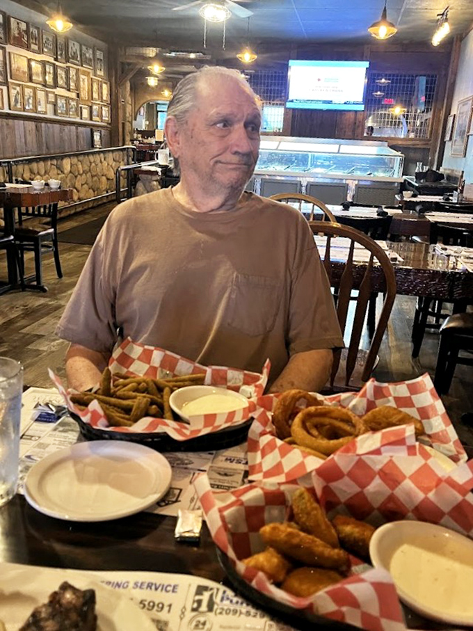 The look of pure contentment says it all&mdash;those onion rings and fries aren't just sides, they're supporting characters in a delicious drama.