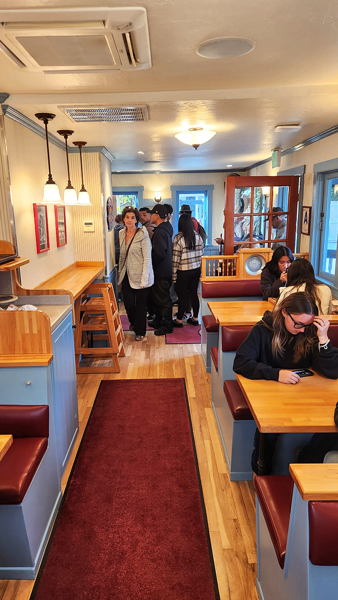 The narrow dining room where strangers become friends, united by the universal language of "mmmmm" and "you have to try this."