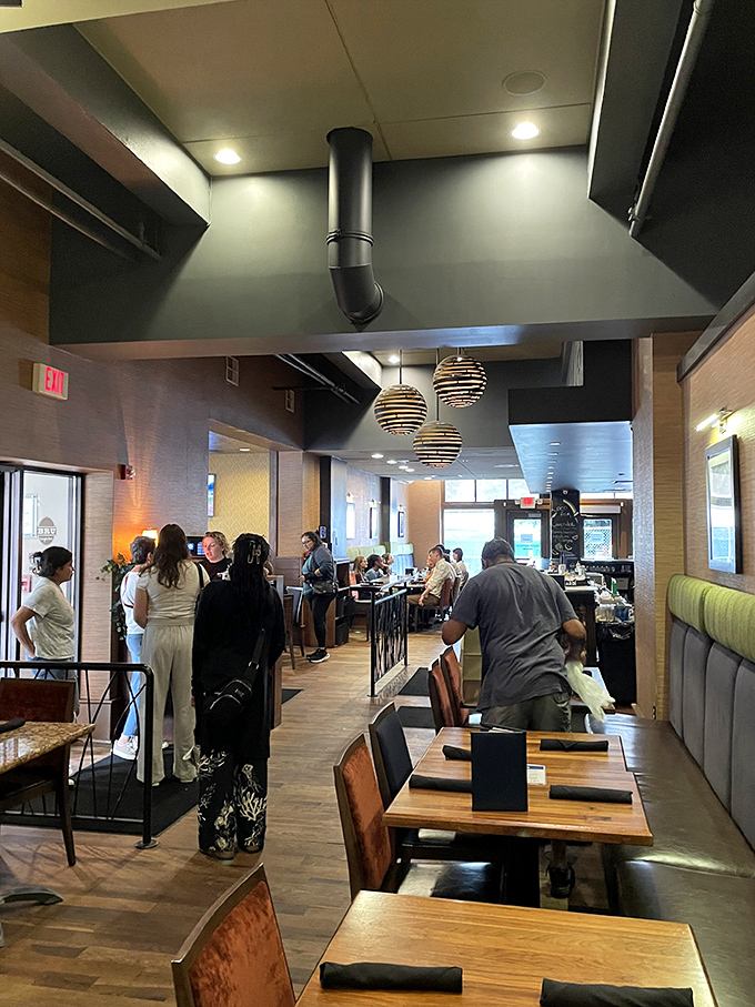 The modern dining room buzzes with the energy of happy eaters. Notice how nobody's looking at their phones? That's the power of a good burger.