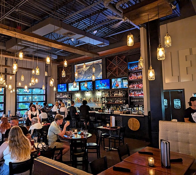 The bar area buzzes with the energy of people making memories over meals, illuminated by mason jar lights that add just the right ambiance.