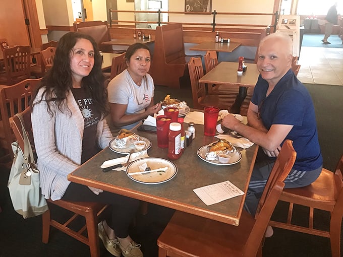 Happy diners with that unmistakable "we've hit the jackpot" glow. The red cups of sweet tea complete this tableau of buffet bliss.