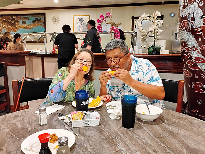 The universal language of good food: two diners enjoying the post-buffet ritual of orange slices, the international symbol for "we regret nothing."