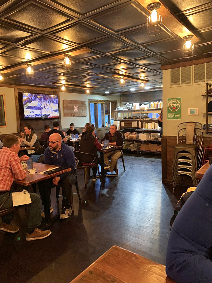 The dining room buzzes with the universal language of burger appreciation. Notice how nobody's talking? That's happiness in progress.