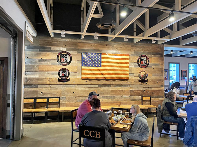 The wall of barbecue achievement watches over diners like smoked meat guardian angels. Those trophies weren't won in a raffle.