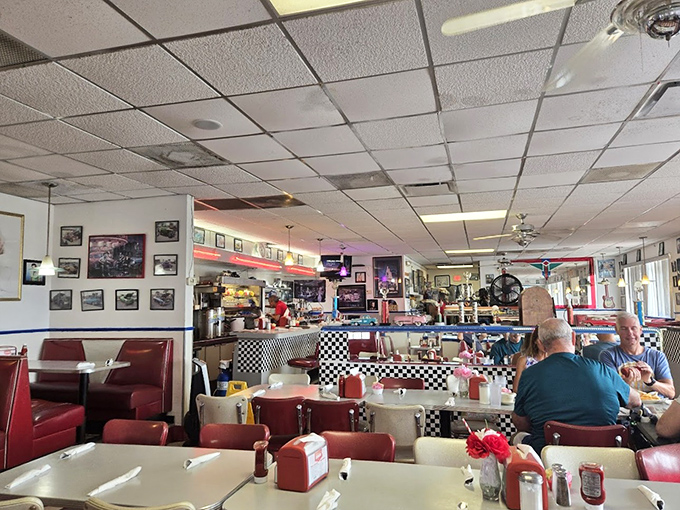Red vinyl booths that have cradled more Florida retirees than all the orthopedic cushions at Bed Bath & Beyond. The checkered floor practically demands a sock hop.