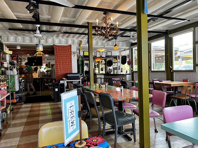 A dining room that feels like it was assembled from the world's coolest yard sales &ndash; mismatched chairs, colorful tables, and pure charm.