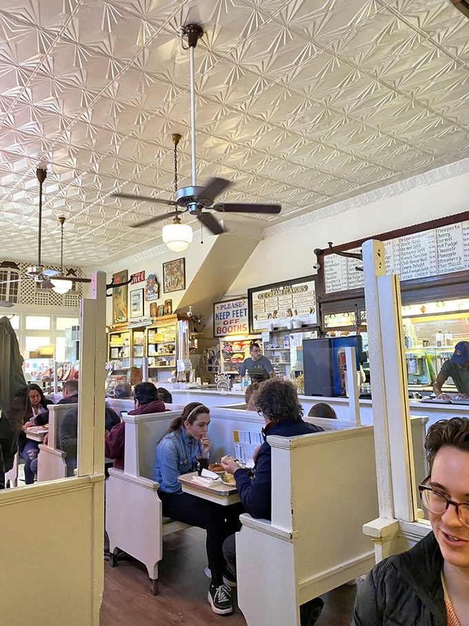 The pressed tin ceiling and vintage ceiling fans hover above conversations happening exactly as they did a century ago.