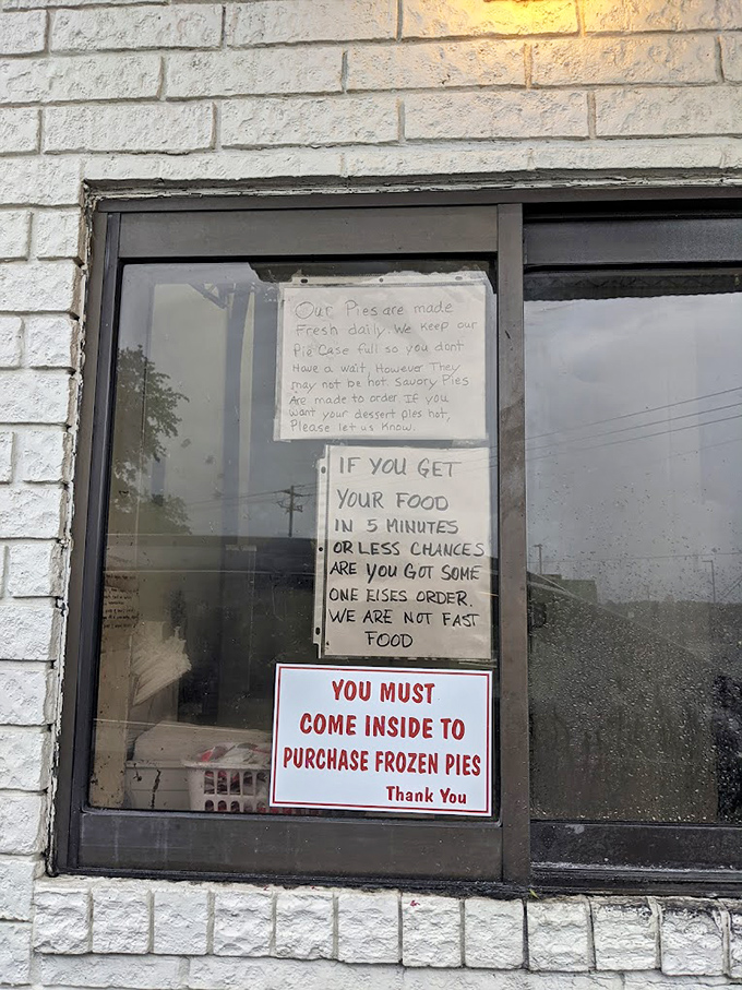 The window sign tells you everything about this place's philosophy: good food takes time, and frozen pies require a proper introduction.