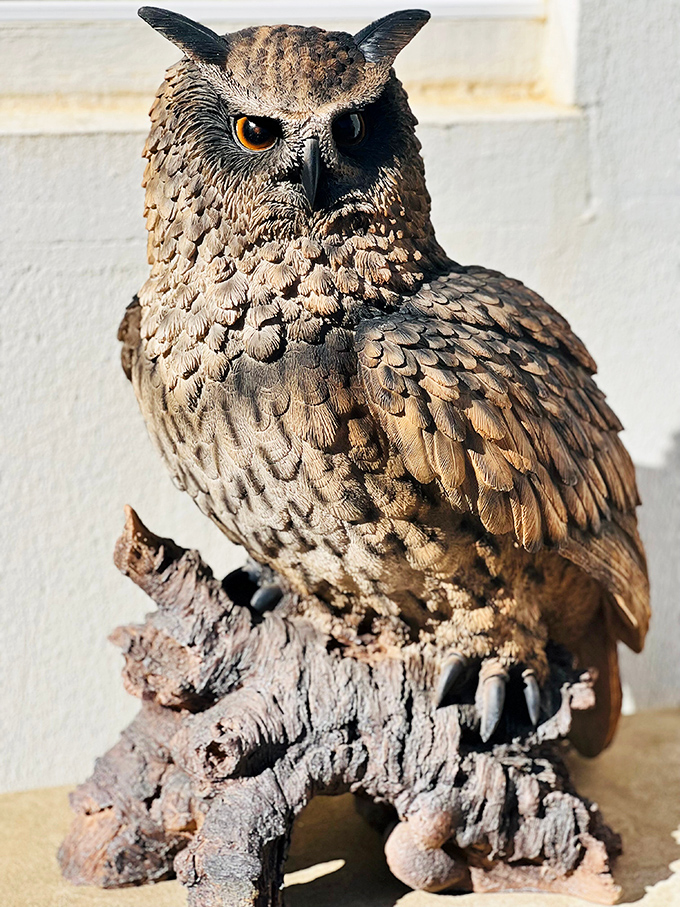 The castle's namesake in sculptural form&mdash;this eagle owl watches with amber eyes that seem to follow you. Magnificent craftsmanship in every feathered detail.