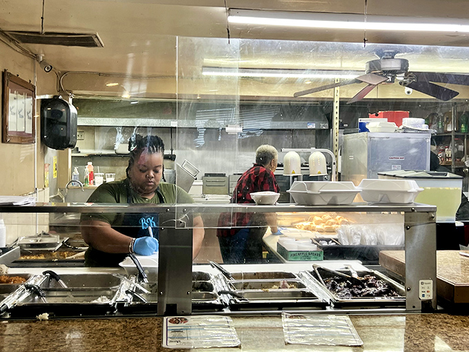 Behind this counter, culinary magic happens with the kind of calm efficiency that five-star kitchens can only dream about.