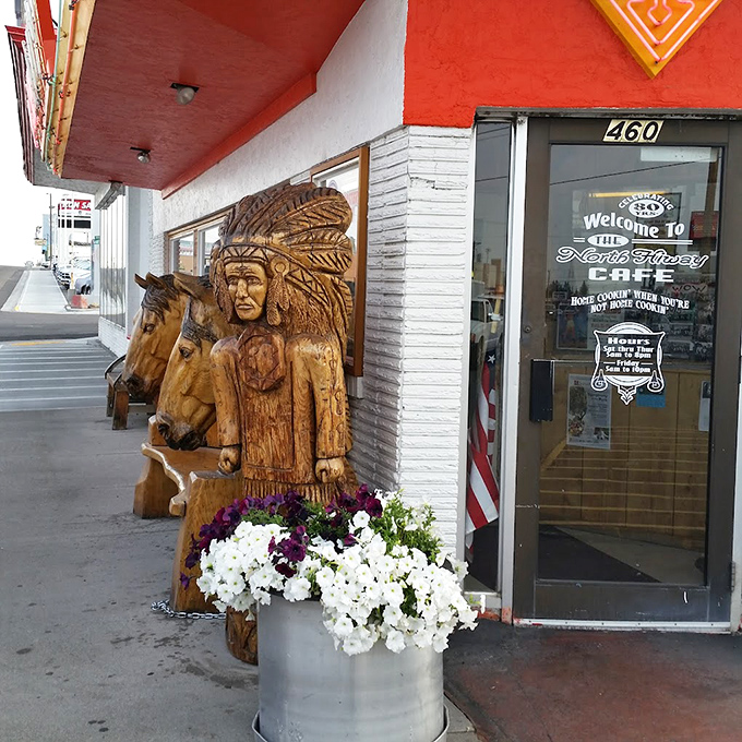 The entrance promises "Home Cooking" and delivers with wooden guardians and flowers that say, "Yes, we care about details."