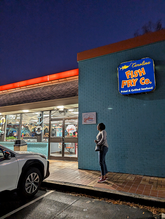 Even at night, the blue sign glows like a beacon, guiding hungry pilgrims to their seafood salvation.
