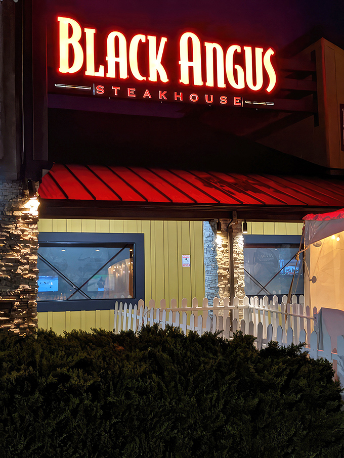 As evening falls, the red neon glow promises a dining experience that prioritizes substance over trendy flash.