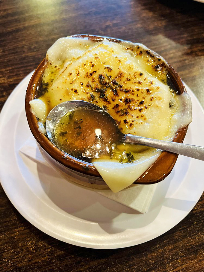 French onion soup with a cheese pull that deserves its own slow-motion sequence. The browned top is nature's perfect crust.