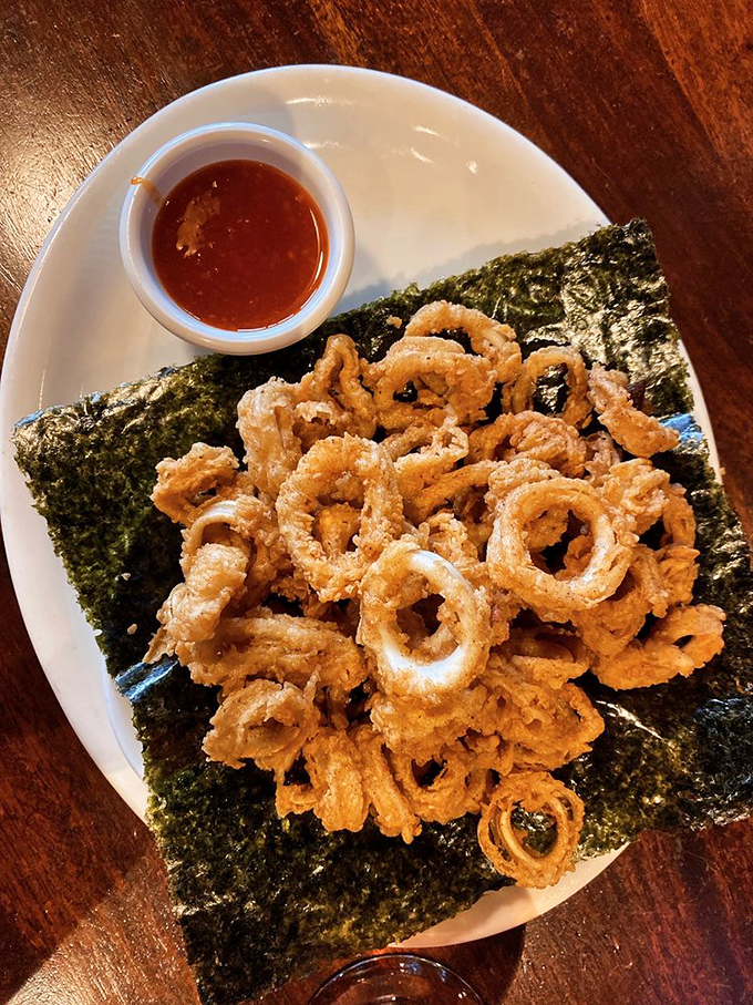 Calamari that didn't get the "rubbery" memo&mdash;these golden rings sit confidently on seaweed like jewelry displayed on velvet.