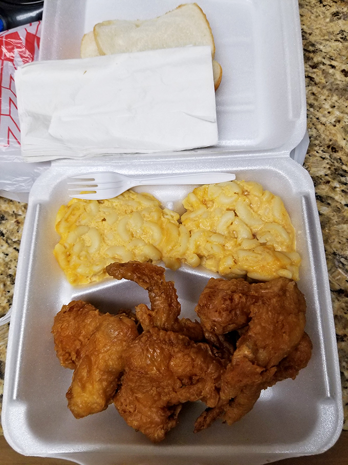Fried chicken so perfectly golden it belongs in Fort Knox, paired with mac and cheese that would make your grandmother both jealous and proud.