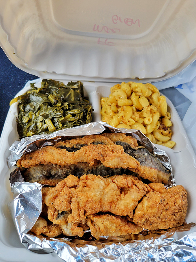 A takeout container that weighs as much as your expectations. Crispy fish, collard greens, and mac and cheese&mdash;the trifecta of soul food bliss.