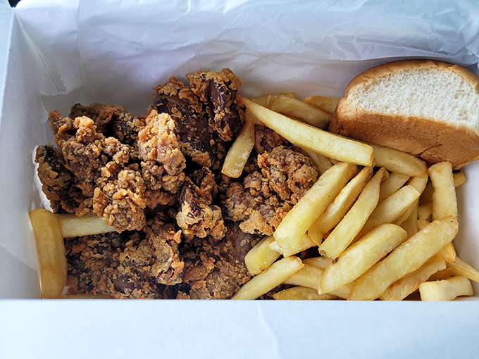 This isn't just a meal; it's a celebration of texture&mdash;crispy coating giving way to tender meat, with fries and bread standing by for backup.