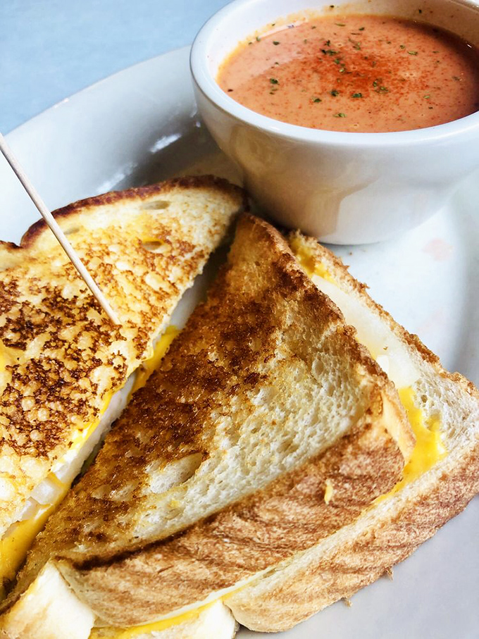 The ultimate comfort food power couple &ndash; golden grilled cheese meeting creamy tomato soup in a romance that warms you from the inside out.