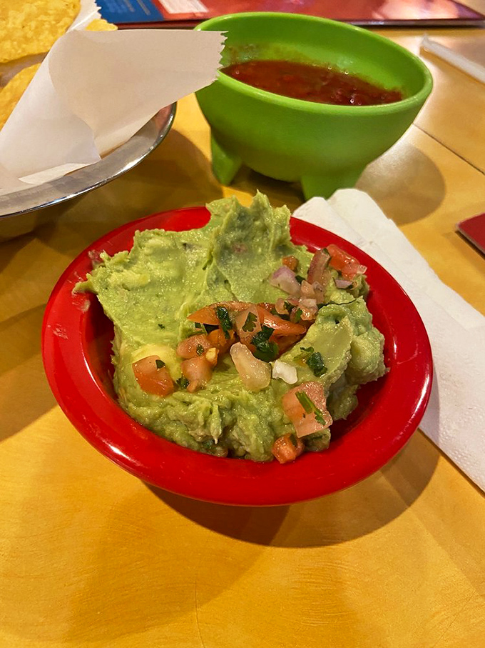 This guacamole isn't just a dip&mdash;it's a vibrant green celebration topped with pico de gallo that makes store-bought versions weep with inadequacy.