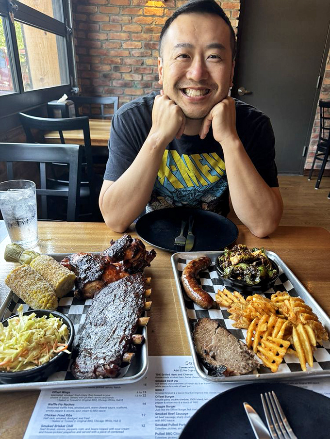 The face of pure barbecue joy&mdash;surrounded by enough smoked meat to make vegetarians reconsider their life choices.