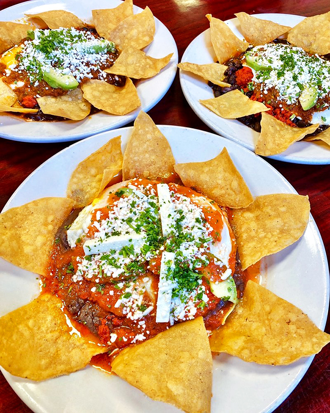 Tortilla chips arranged like sun rays around eggs and beans&mdash;breakfast that's both a feast for the stomach and the Instagram feed.