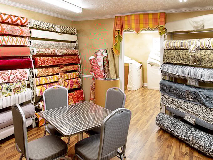 The consultation station: where fabric dreams meet practical reality. Those chairs have heard thousands of decorating schemes.