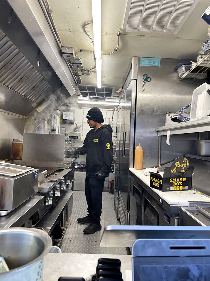 The compact kitchen ballet requires precision and focus. Every inch of space serves a purpose in the quest for burger perfection.